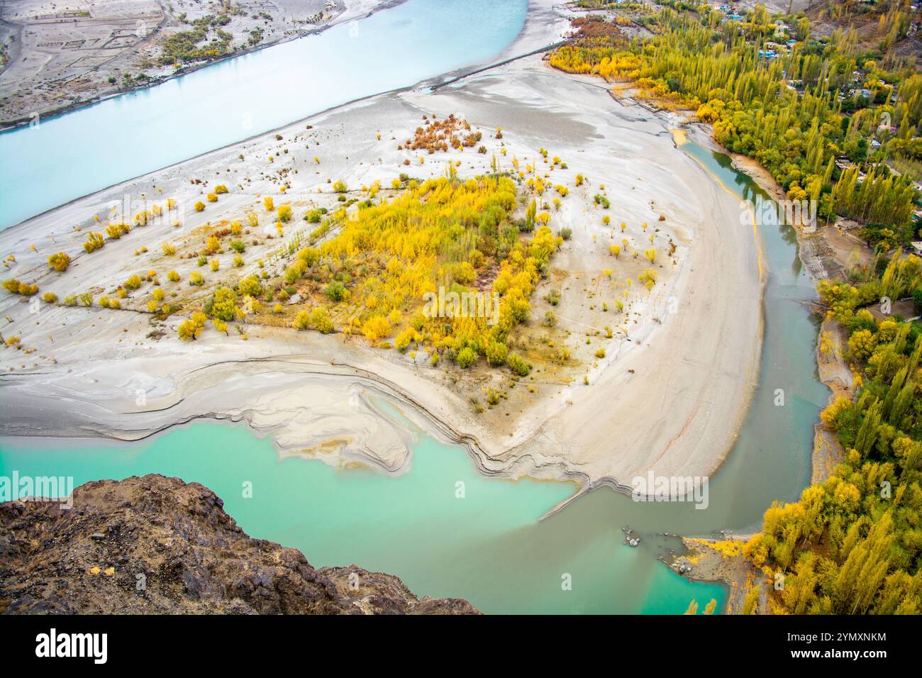 Autumn trees around the Indus river in the Karakoram mountains range ...