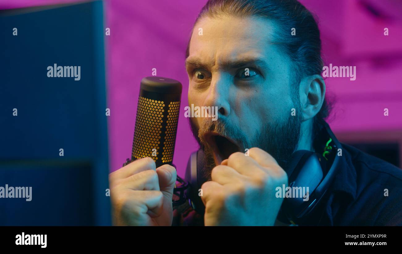 Shocked Caucasian man angry vlogger talking microphone mic addicted ...