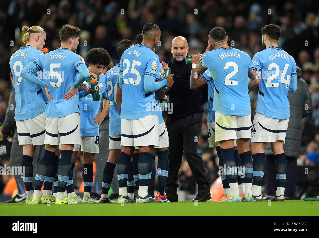 Manchester City manager Pep Guardiola gives a pep talk to the players ...