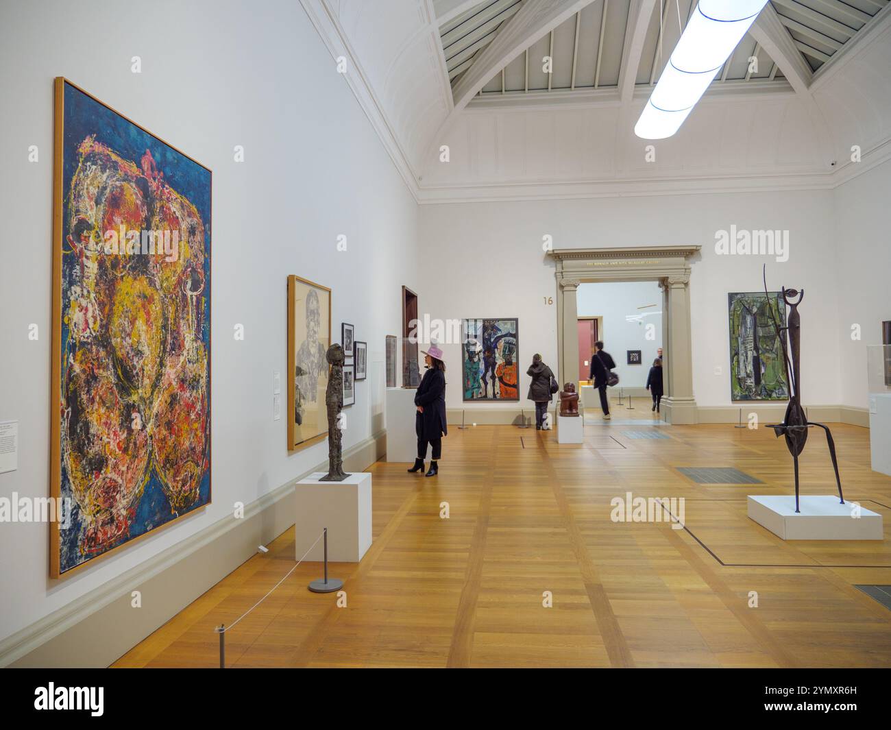 People looking at the artworks inside the Tate Britain art gallery ...