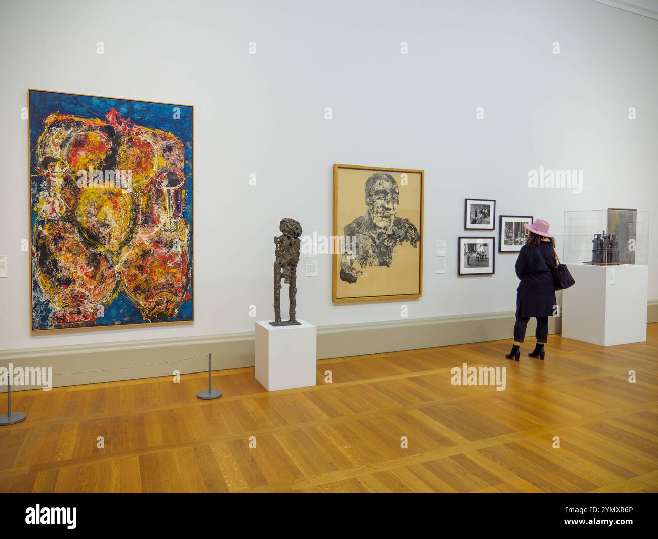 People looking at the artworks inside the Tate Britain art gallery ...