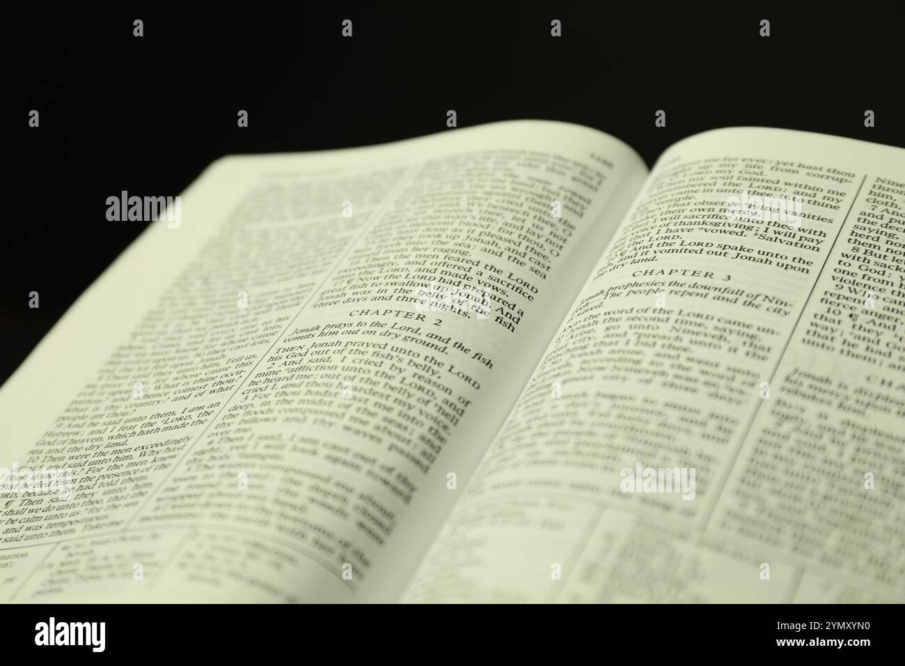 Open Holy Bible in English language on black background, closeup Stock ...