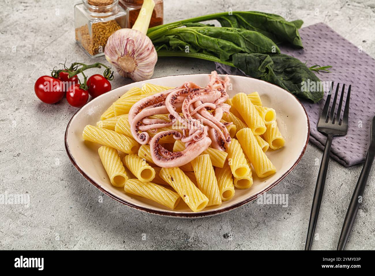 Italian cuisine - pasta tortiglioni with squid tentacles Stock Photo ...