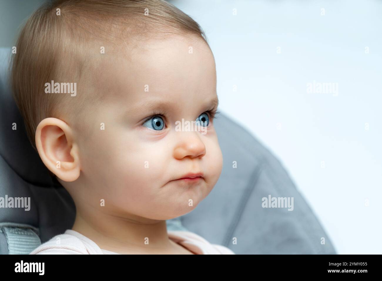 Pouting baby with blue eyes in soft light. Concept of innocence and ...