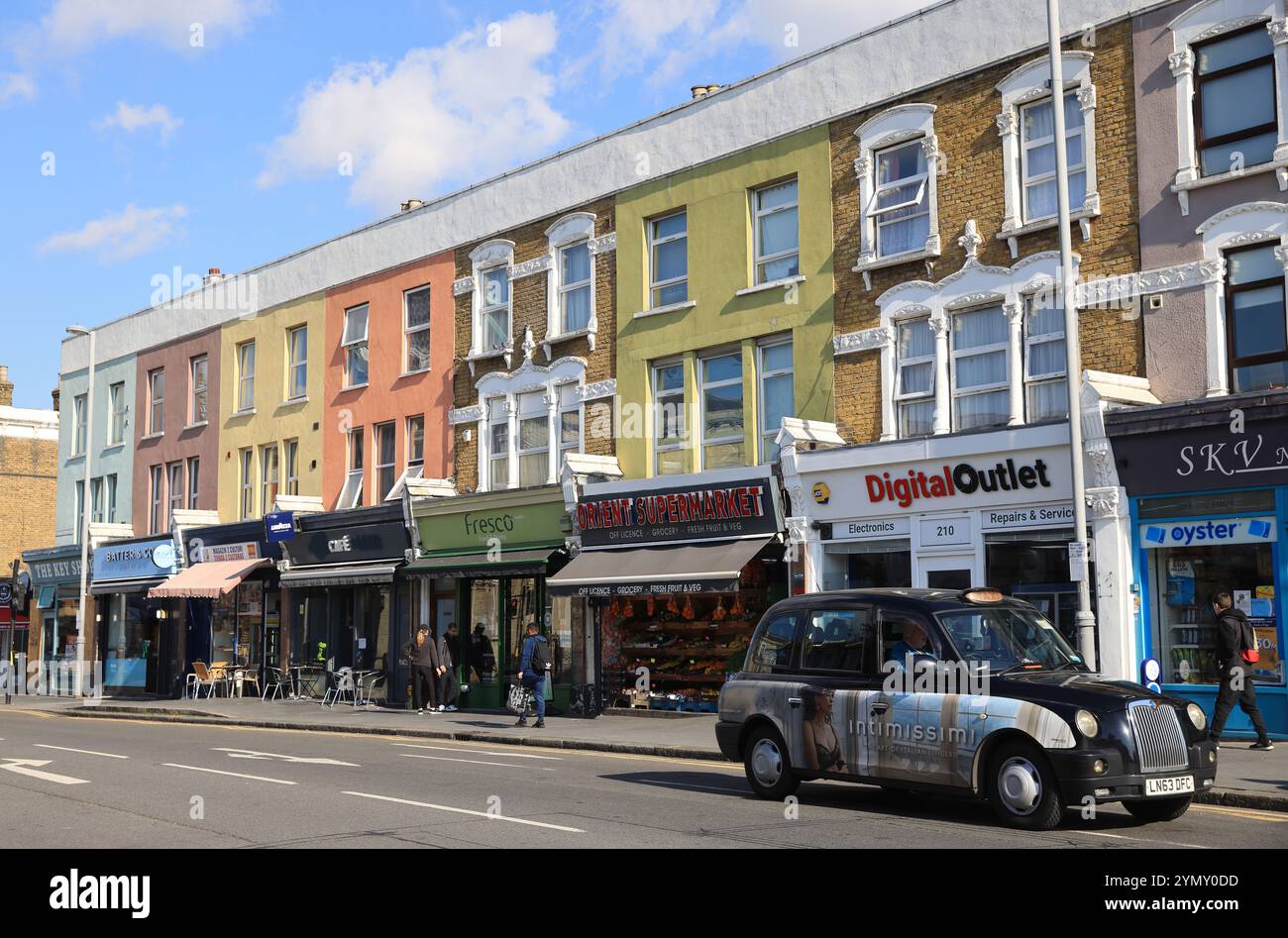 Pastel colours above shop fronts on Leyton High Road, NE London, UK ...