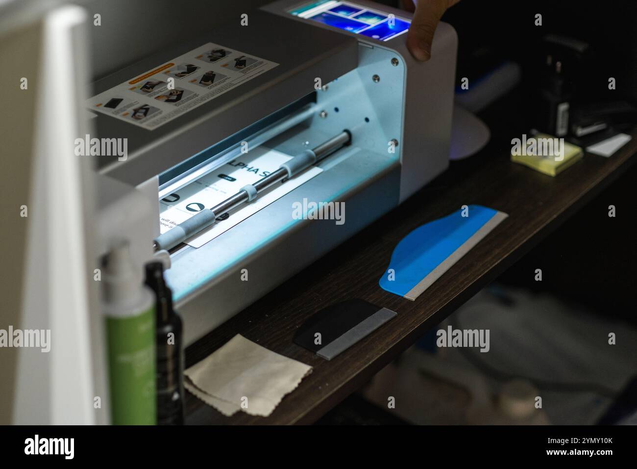 Operator uses a precise cutting plotter for hydrogel film preparation ...