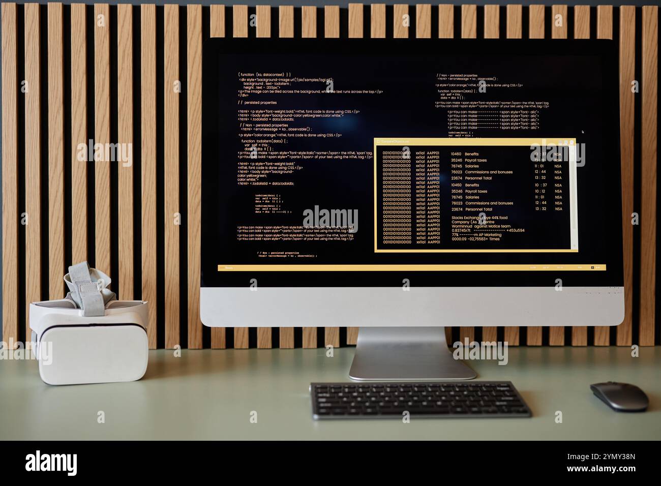 Modern desktop computer displaying coding lines with wooden partition ...