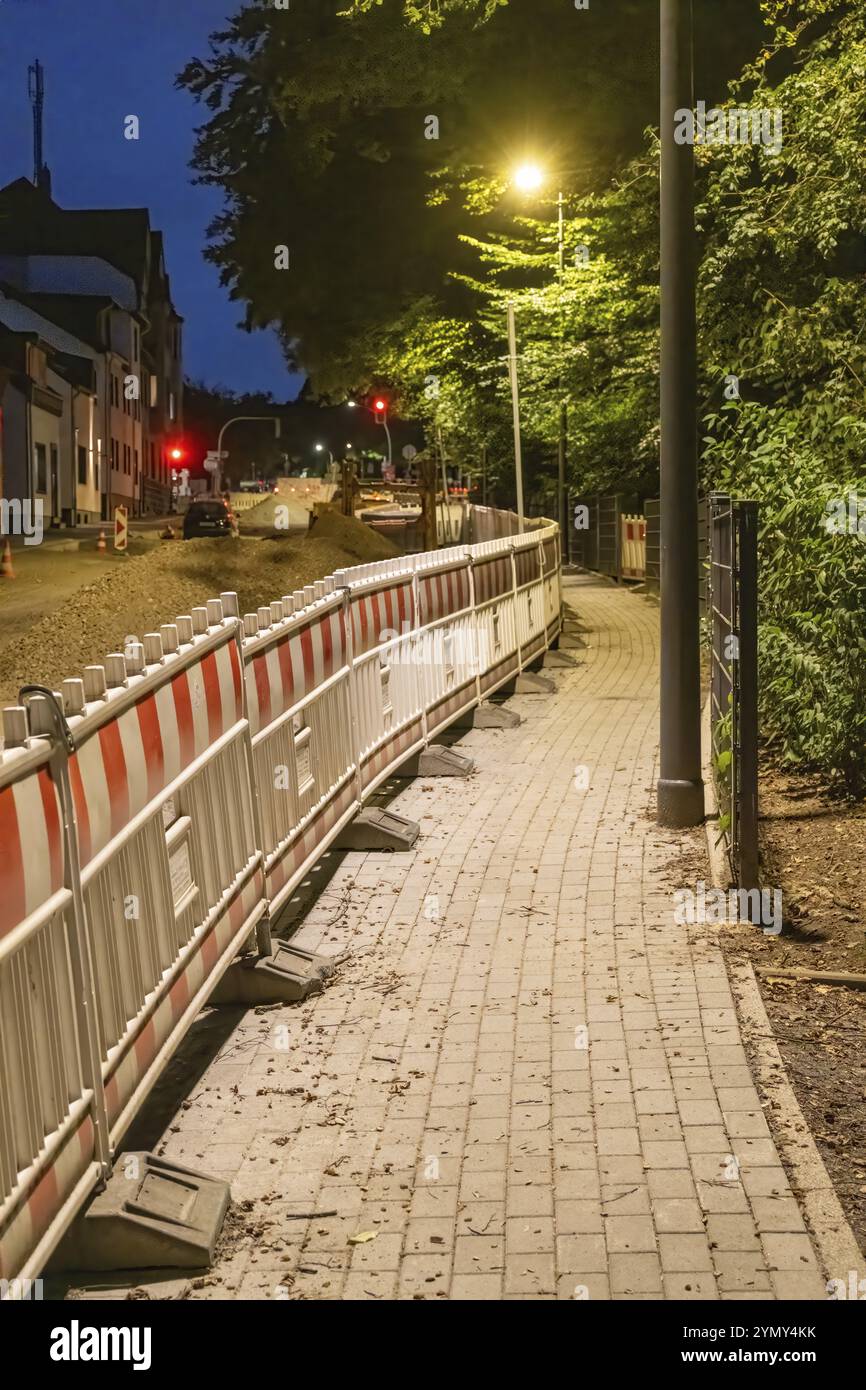 Roadworks with barriers and warning lights at night Stock Photo - Alamy