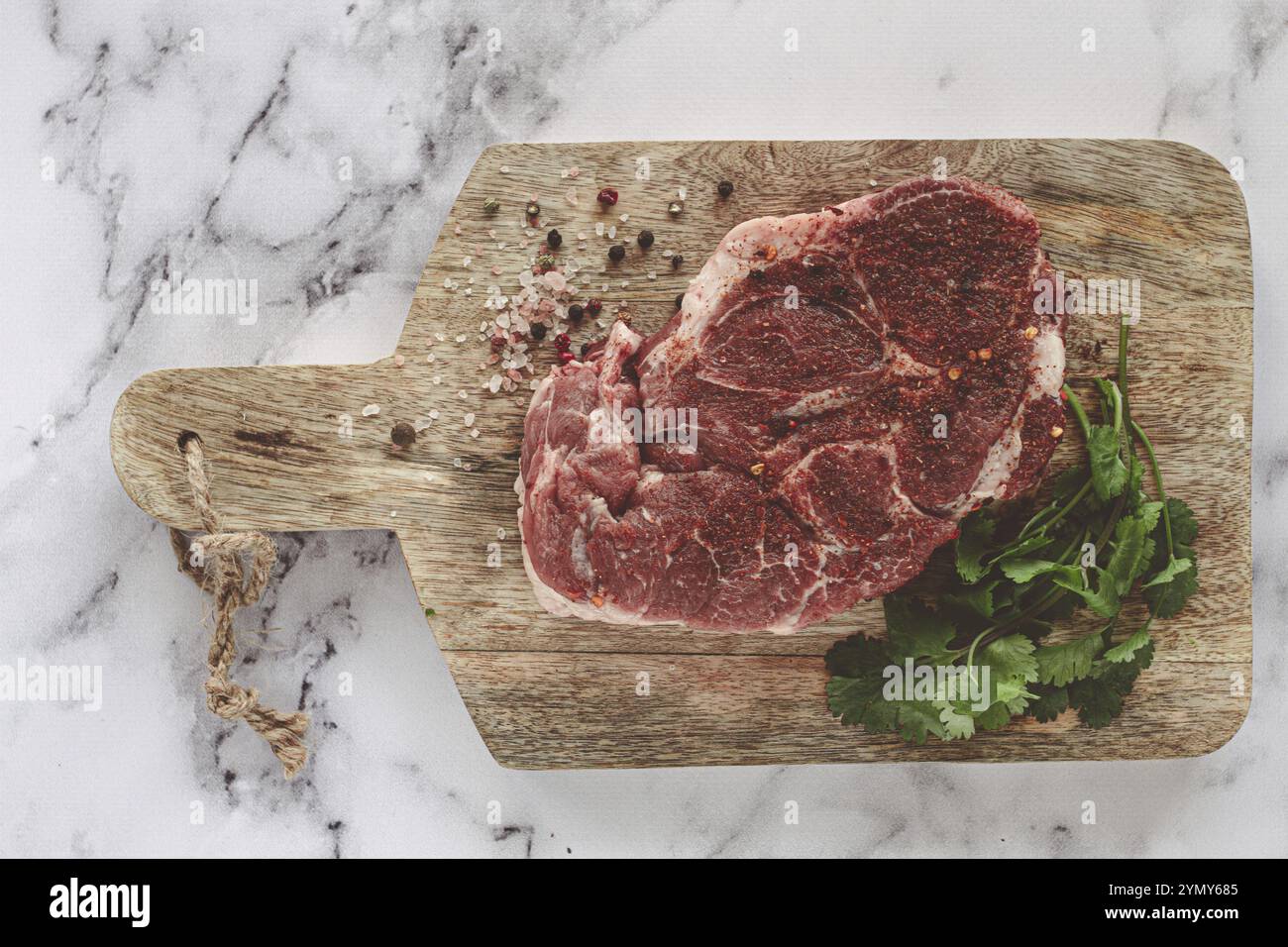 Raw pork steak, pork neck, on a chopping board, marble table, top view ...
