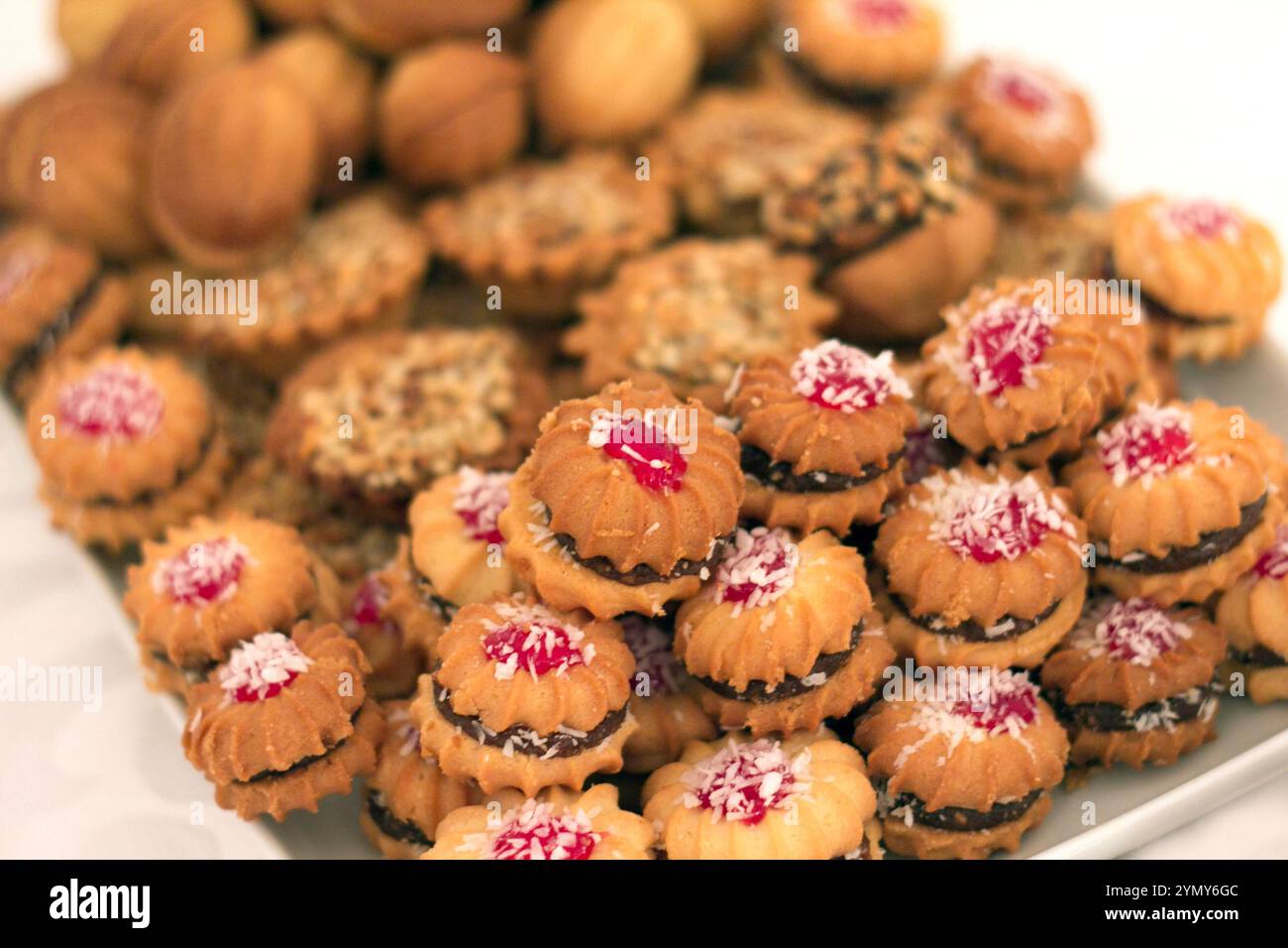 Cookies with a chocolate stuffing, nutlets, jam and coconut shaving ...