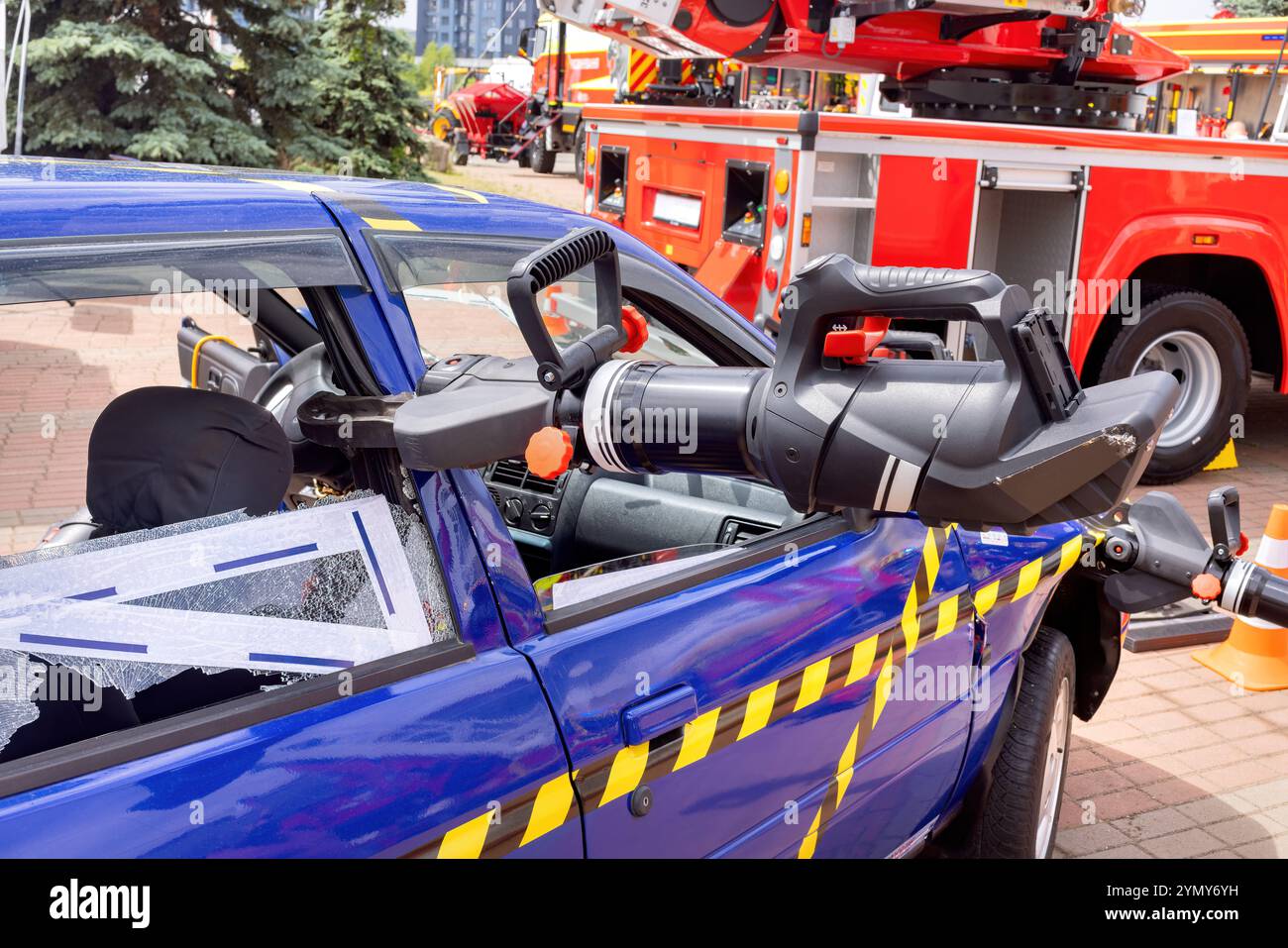 Emergency response demonstration using tools on a blue vehicle in a ...