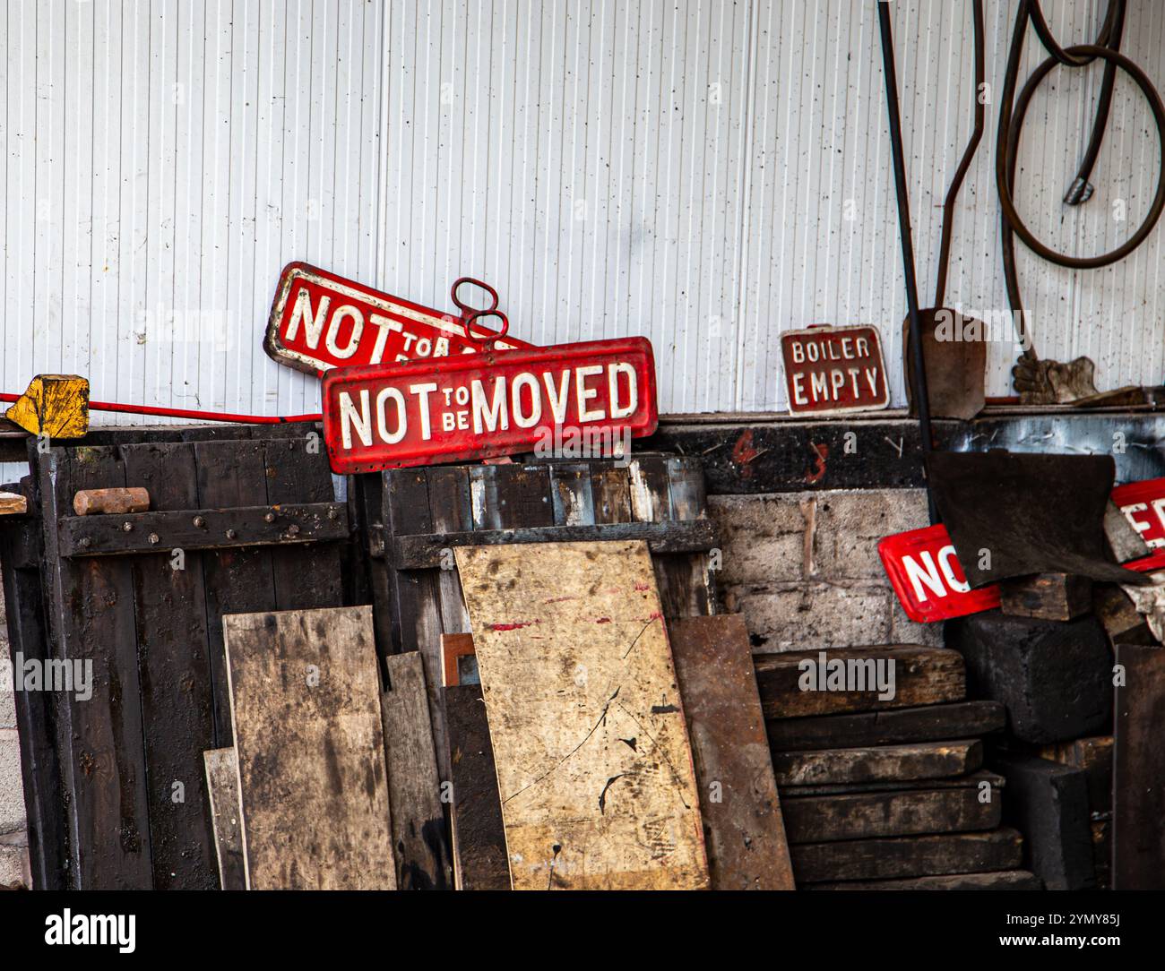 Rustic workshop with wooden planks and vintage safety signs leaning ...