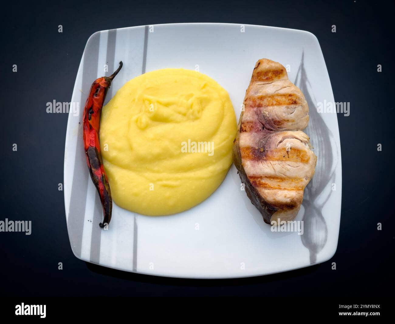 Grilled fish served with mashed potatoes and a roasted pepper Stock ...