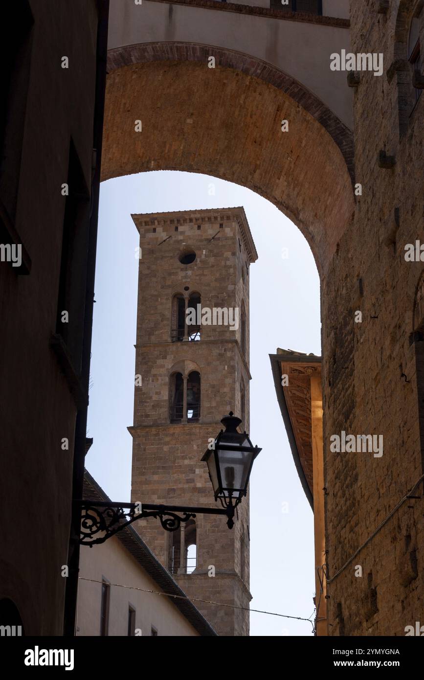 Old Romanesque bell tower of a church in downtown Volterra, Italy ...
