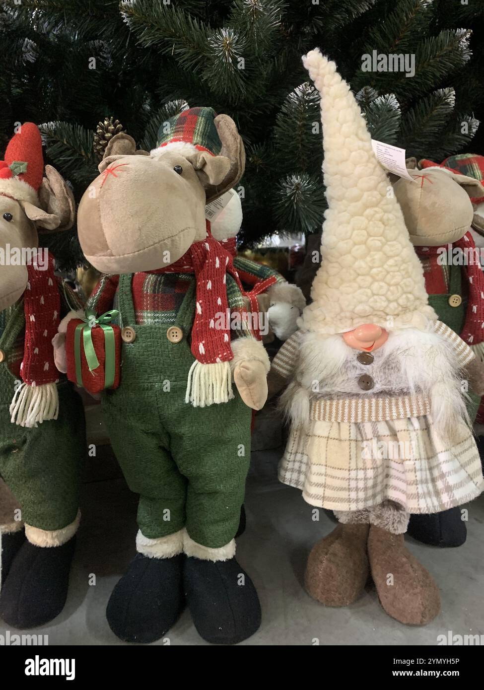 Adorable plush moose and gnome figurines stand festively dressed in ...