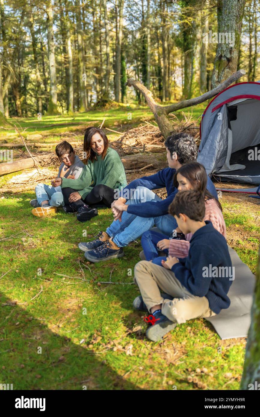 Vertical full length photo of a caucasian family sunbathing enjoying ...