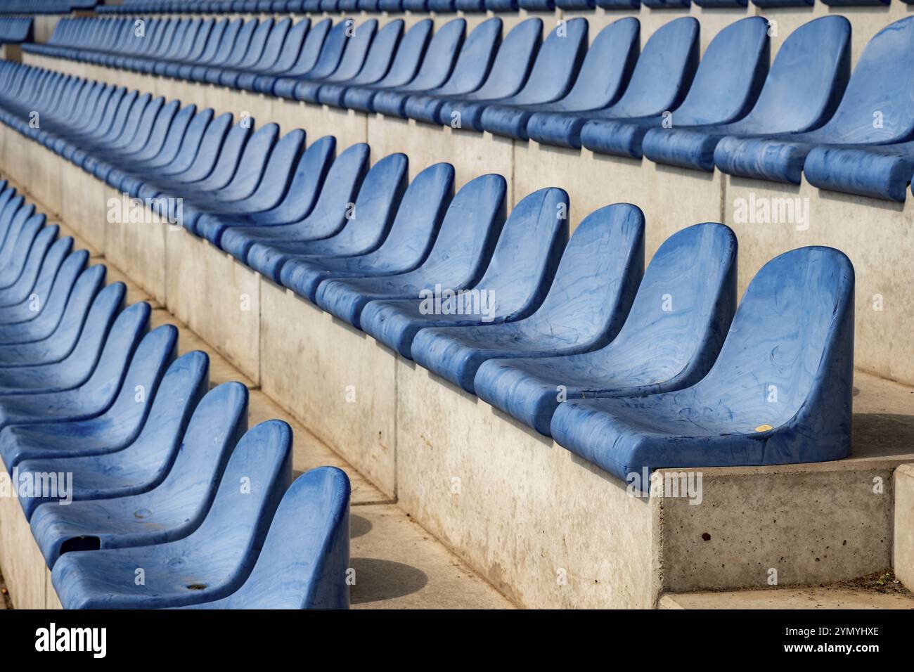 Long rows of blue seats on a sports field stand Stock Photo - Alamy