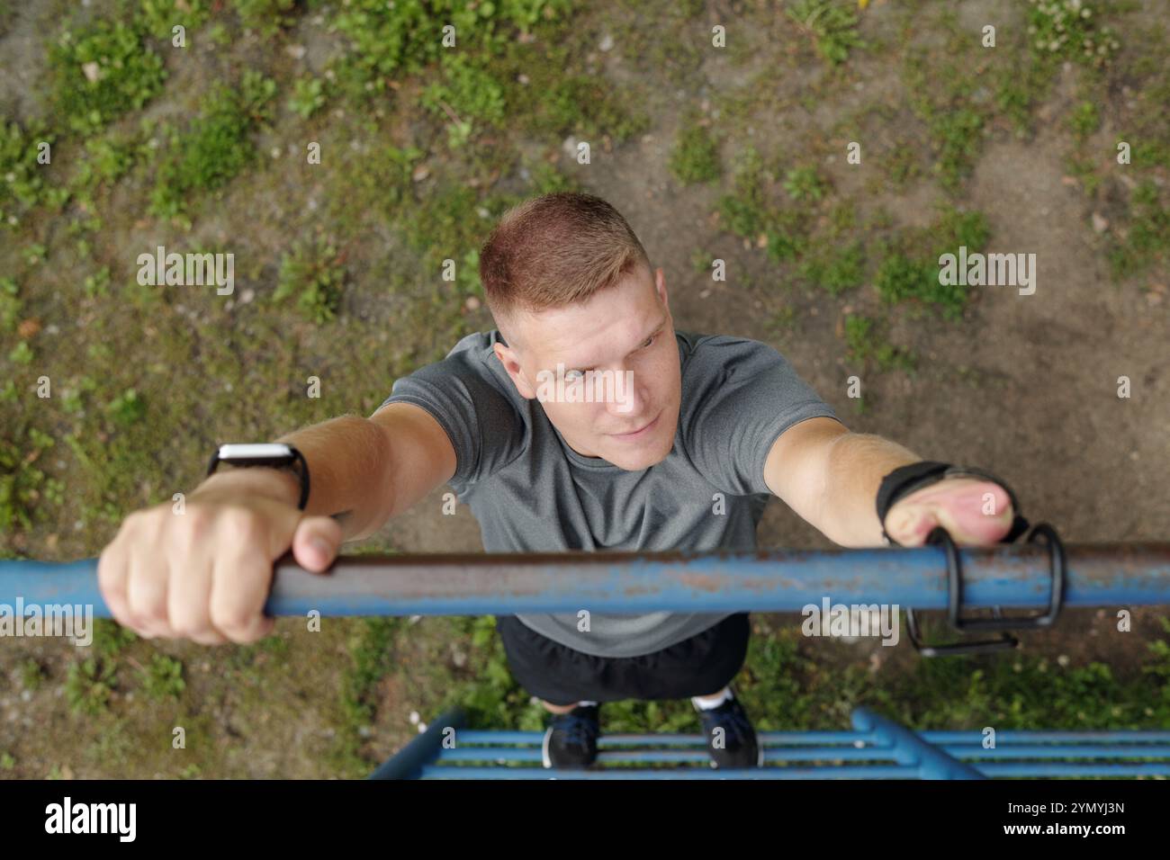 Man engaging in a workout on outdoor monkey bars, demonstrating ...