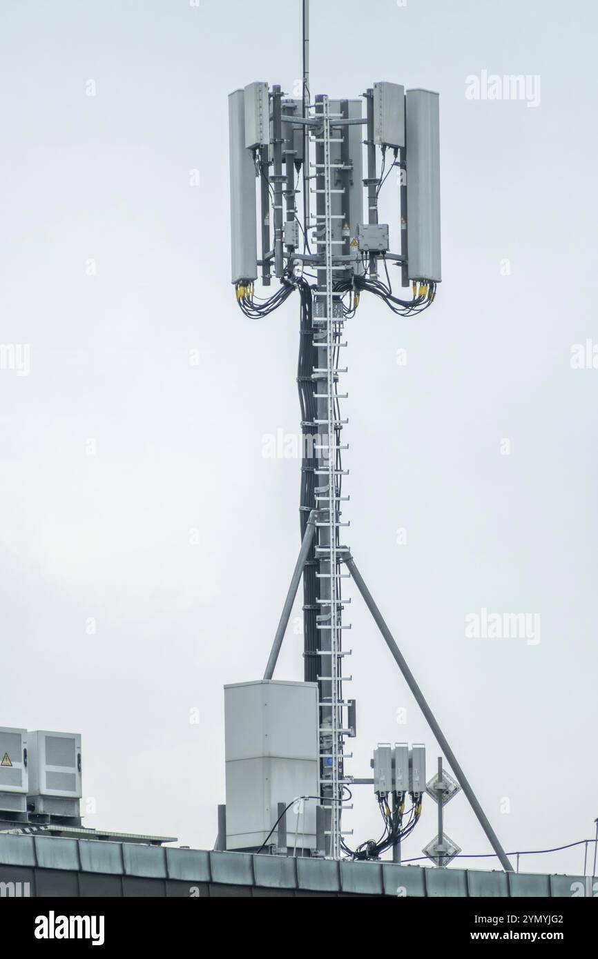 Large mobile radio antennas on an office roof Stock Photo - Alamy