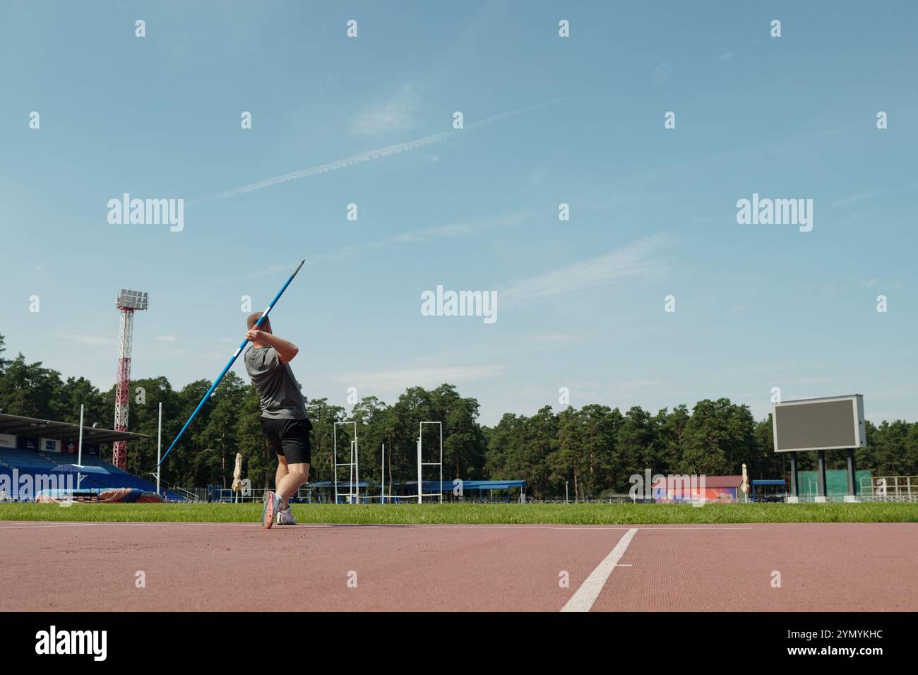 Athlete throwing javelin during outdoor training session in sports ...