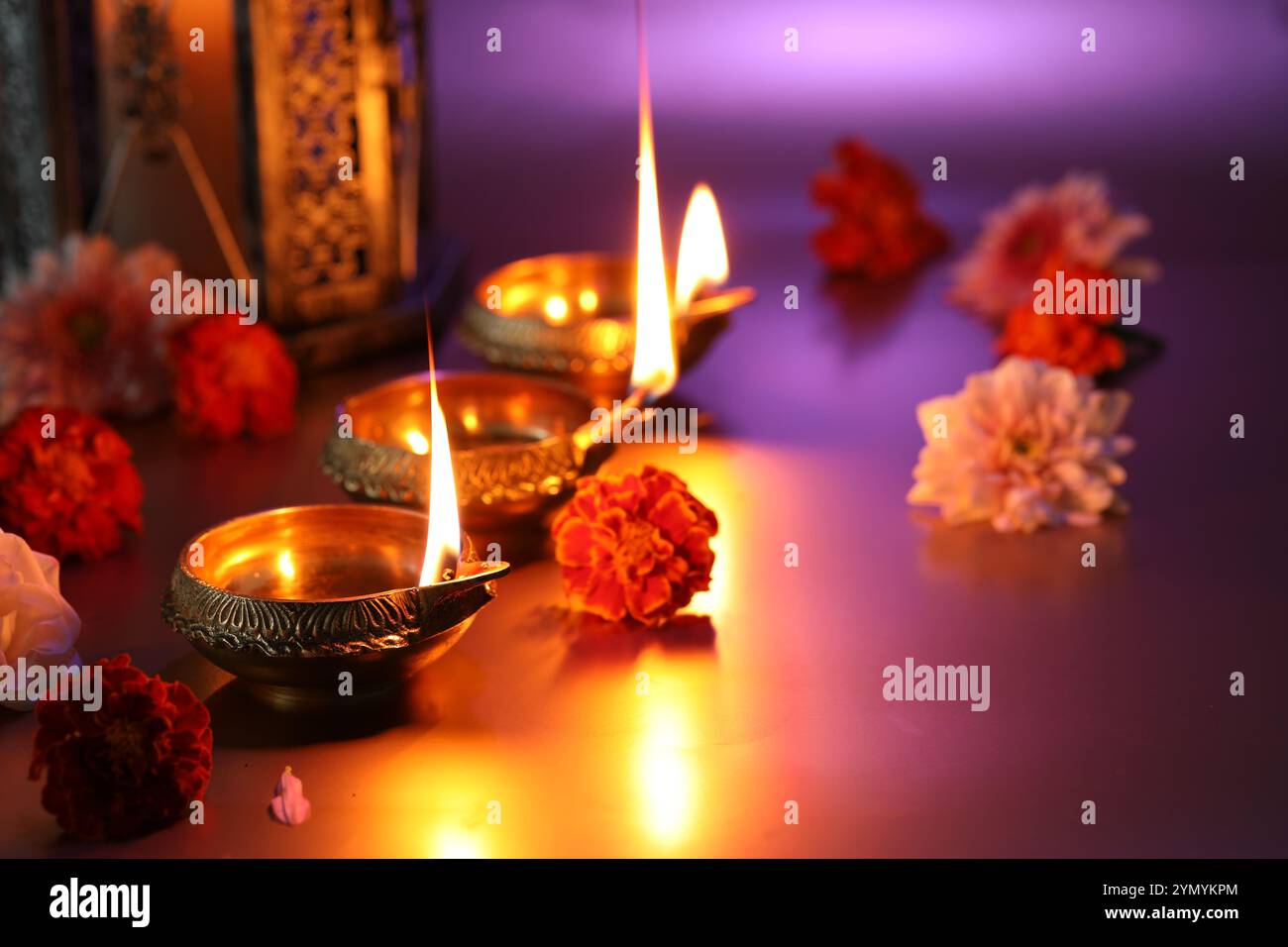 Diwali celebration. Diya lamps and beautiful flowers on color ...