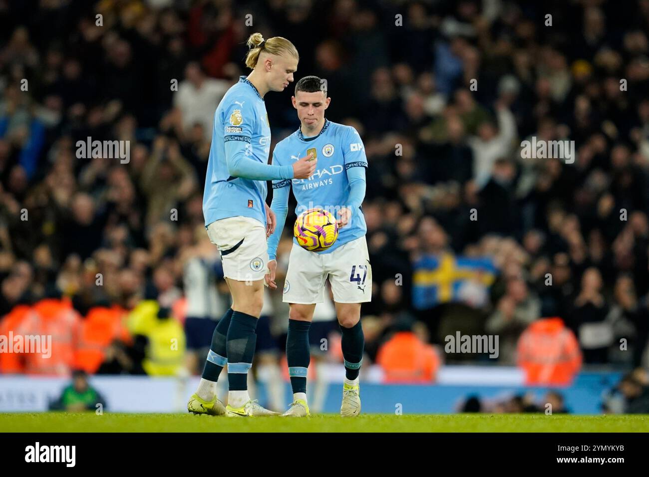 Manchester City's Phil Foden, right, and Erling Haaland stand near the ...