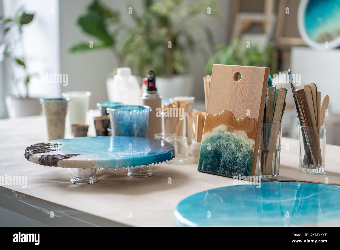 Artist workbench creating paintings artworks from epoxy resin. Table ...