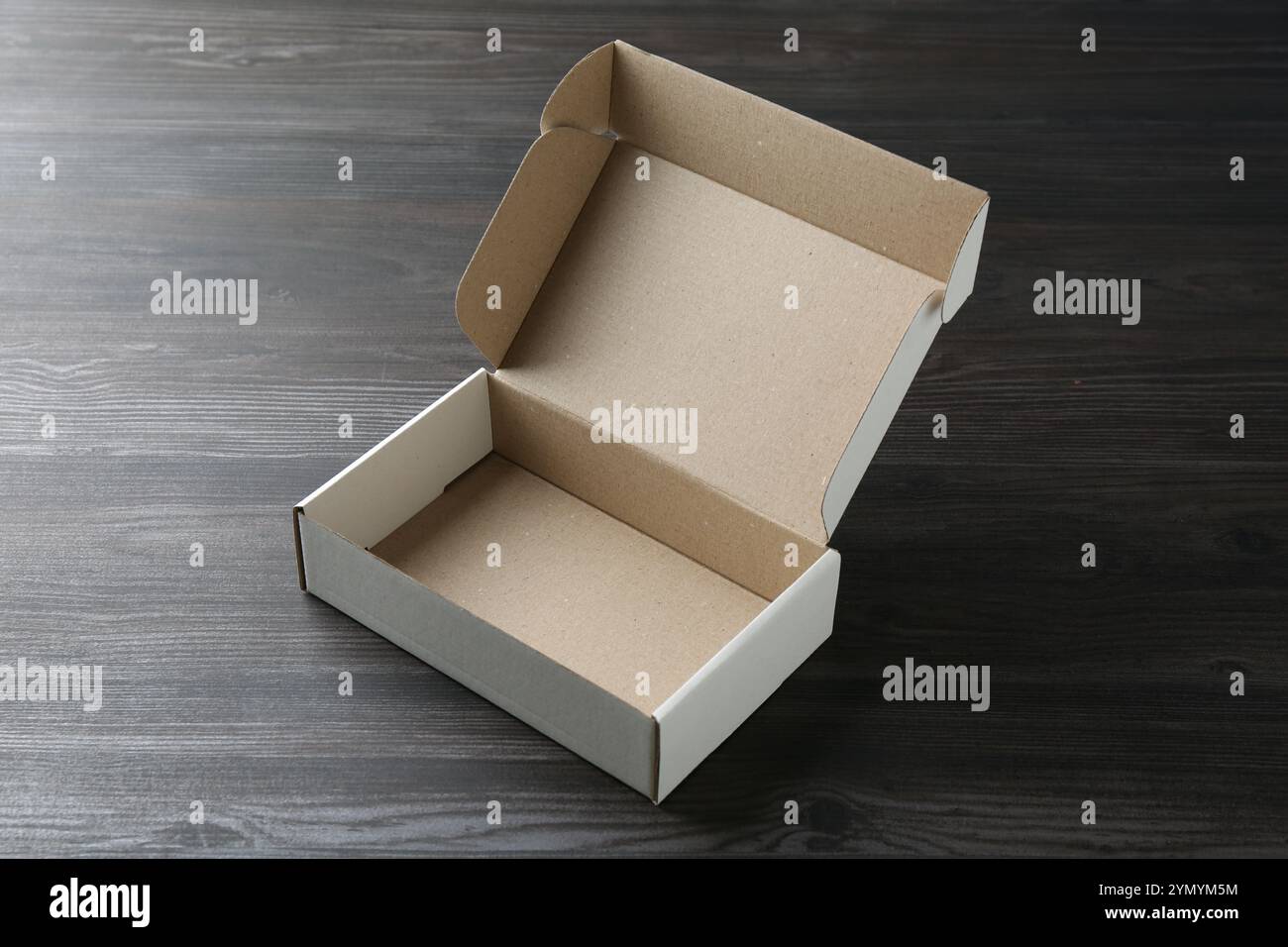 One open cardboard box on wooden background. Mockup for design Stock ...