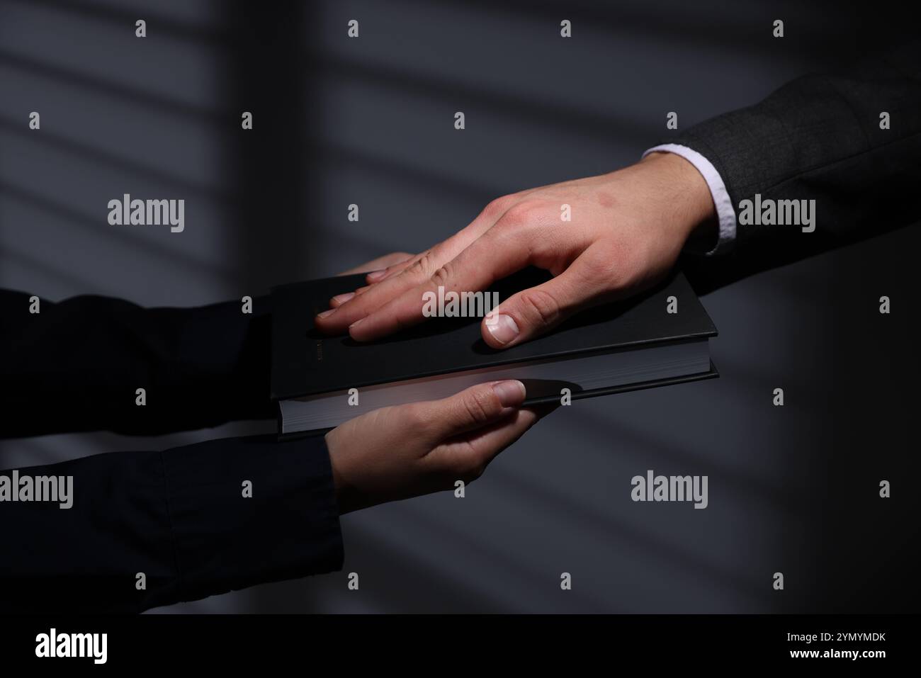 Man taking oath with his hand on Bible indoors, closeup Stock Photo - Alamy