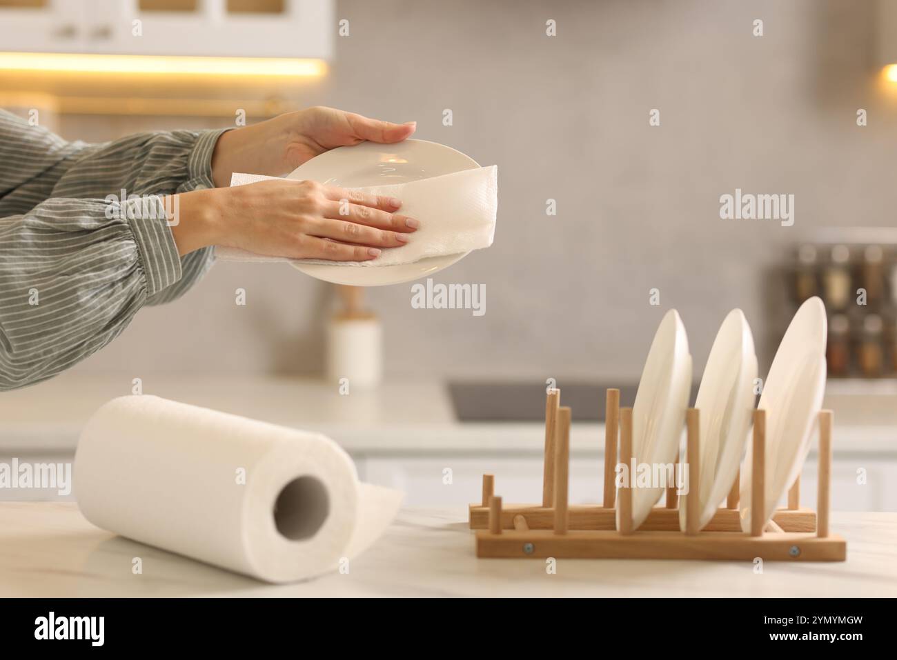Woman wiping plate paper hi-res stock photography and images - Alamy