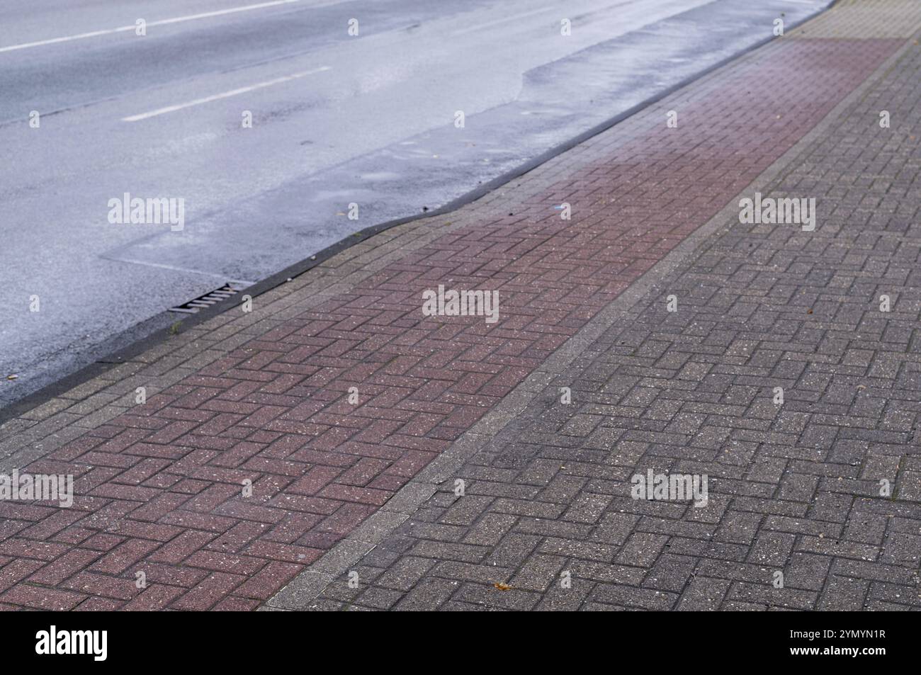 Wet street, sidewalk, bike path with traffic signs Stock Photo - Alamy