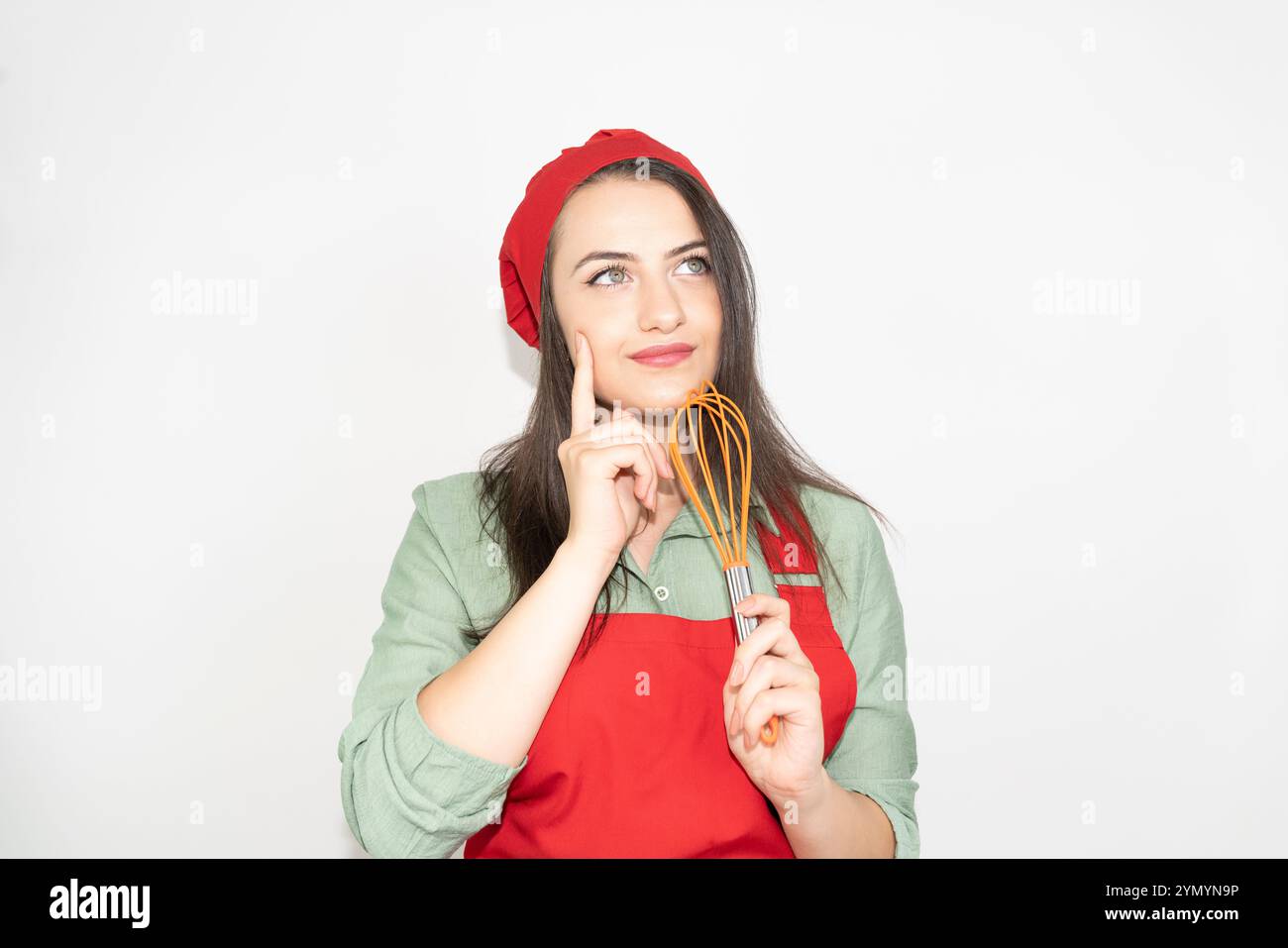 Portrait of young woman chef wearing red apron isolated white color ...