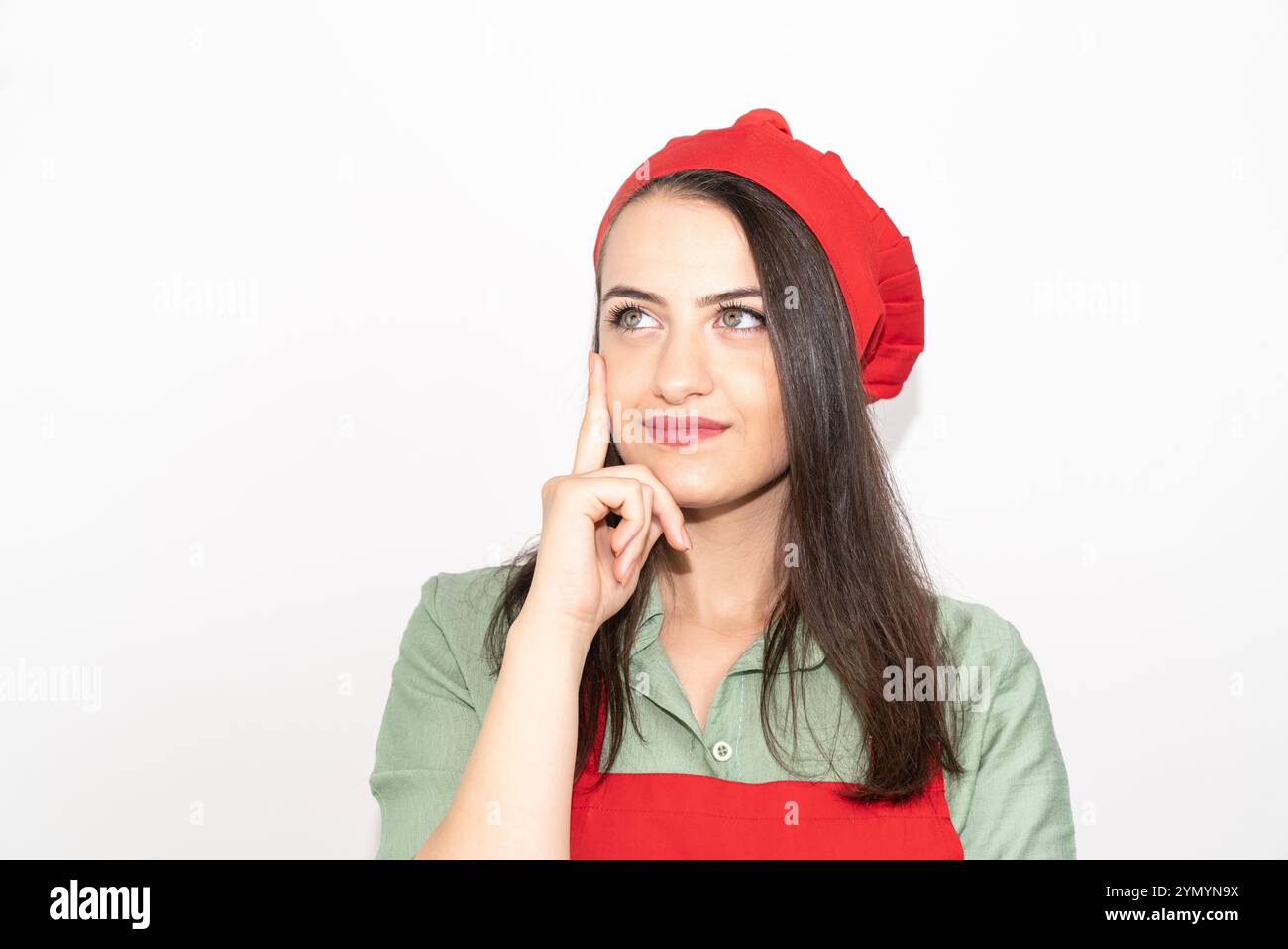 Portrait of young woman chef wearing red apron isolated white color ...