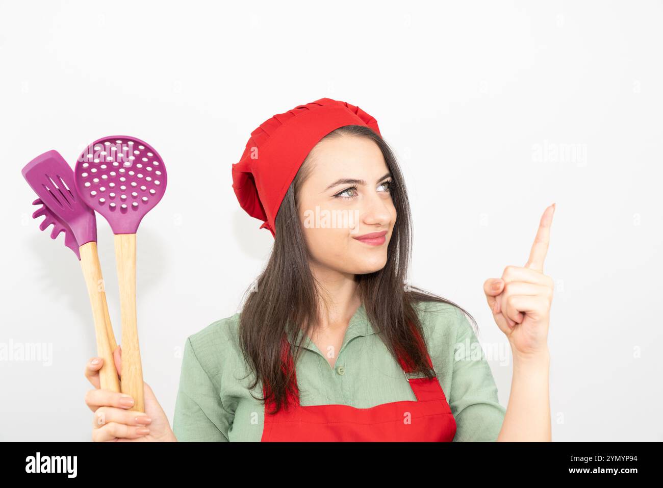 Portrait of young woman chef wearing red apron isolated white color ...