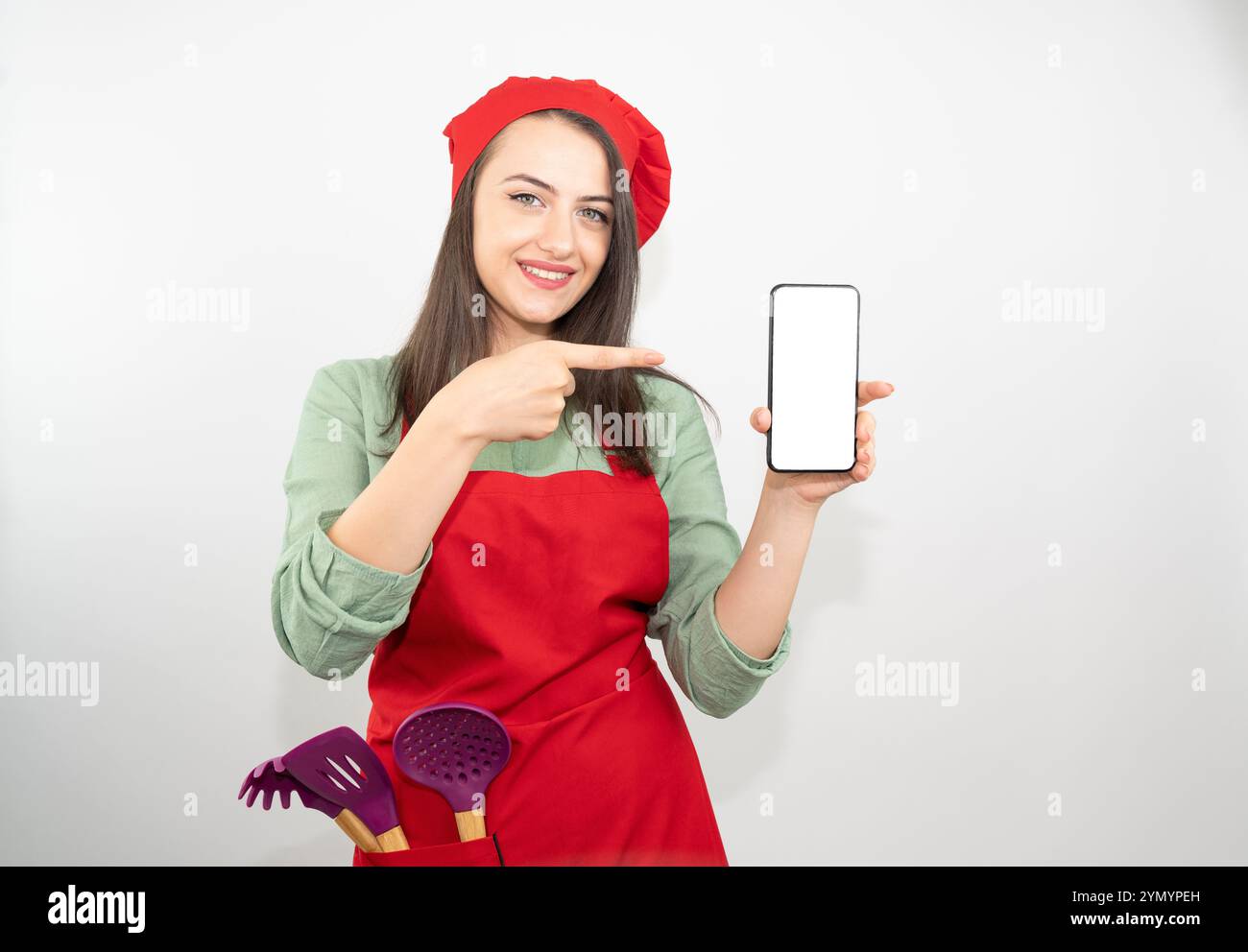 Chef woman wearing apron showing white screen of smartphone Stock Photo ...