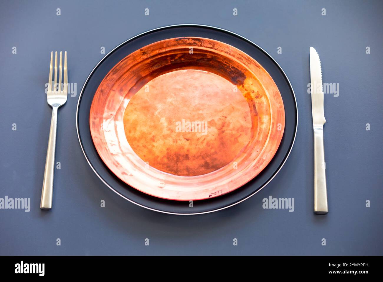 Empty plate top view with metal cutlery next to it Stock Photo - Alamy