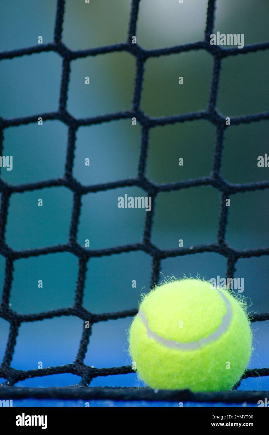 a ball at the base of a padel court net, racket sport background ...