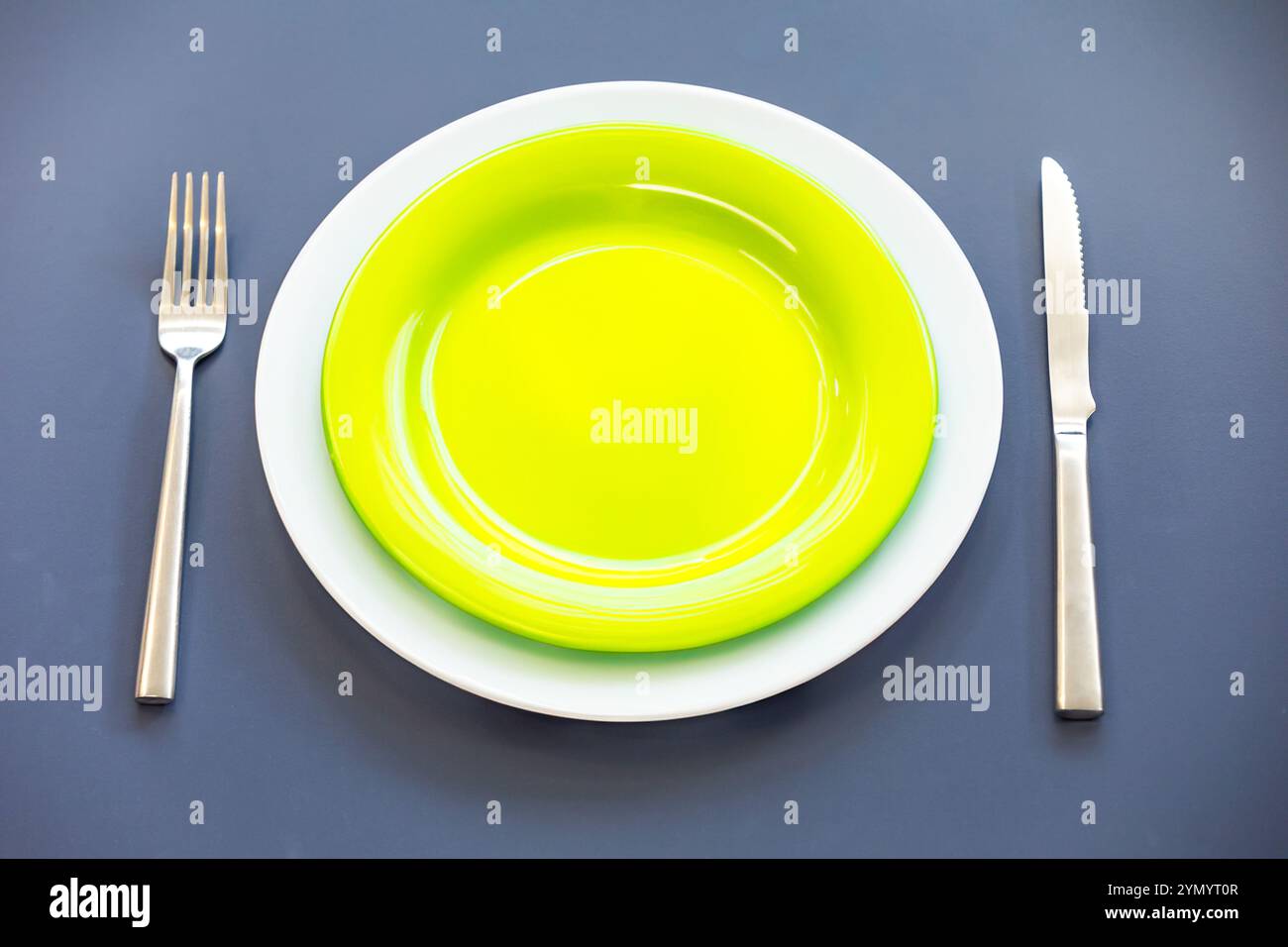 Empty plate top view with metal cutlery next to it Stock Photo - Alamy