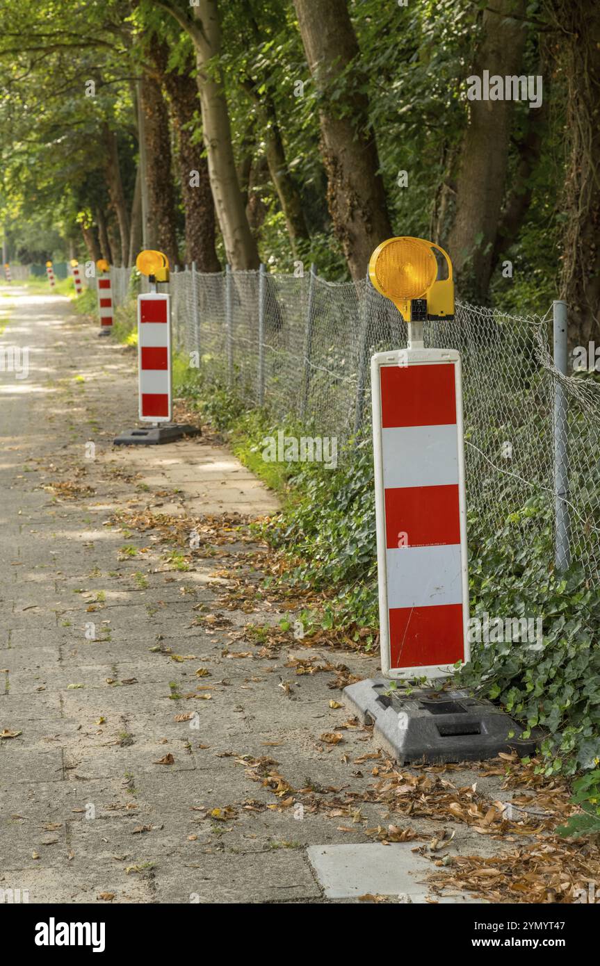 Walkway with wire fence and warning beacons Stock Photo - Alamy