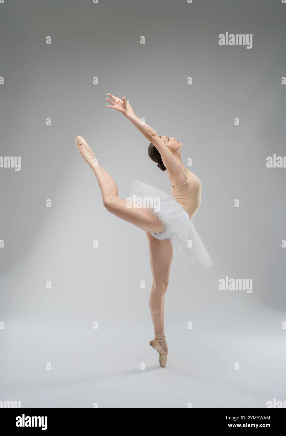 Ballet dancer performing an elegant leap in a studio setting Stock Photo - Alamy