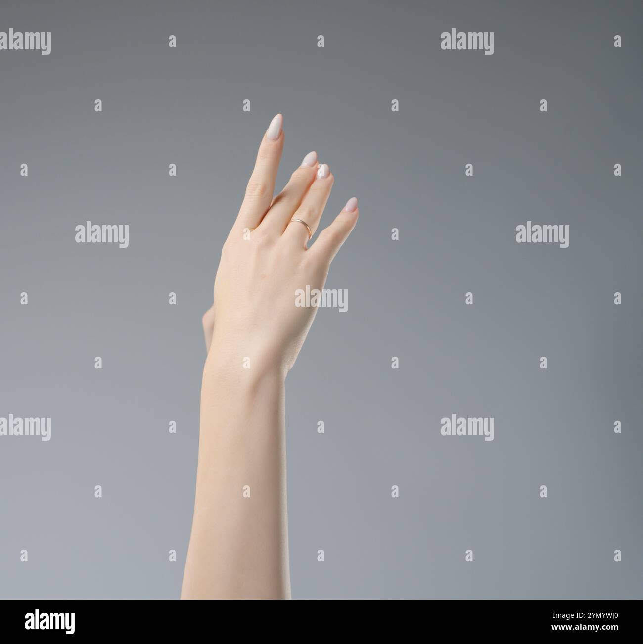 Hand gesture expressing greeting or invitation in neutral background ...