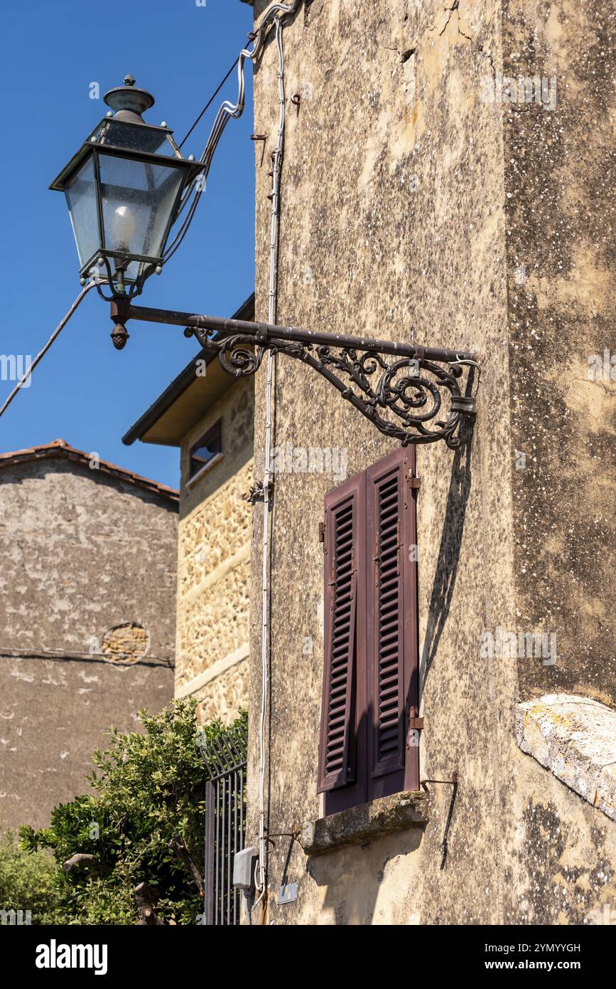 Old classical street lights at the facade of an old house in Volterra ...