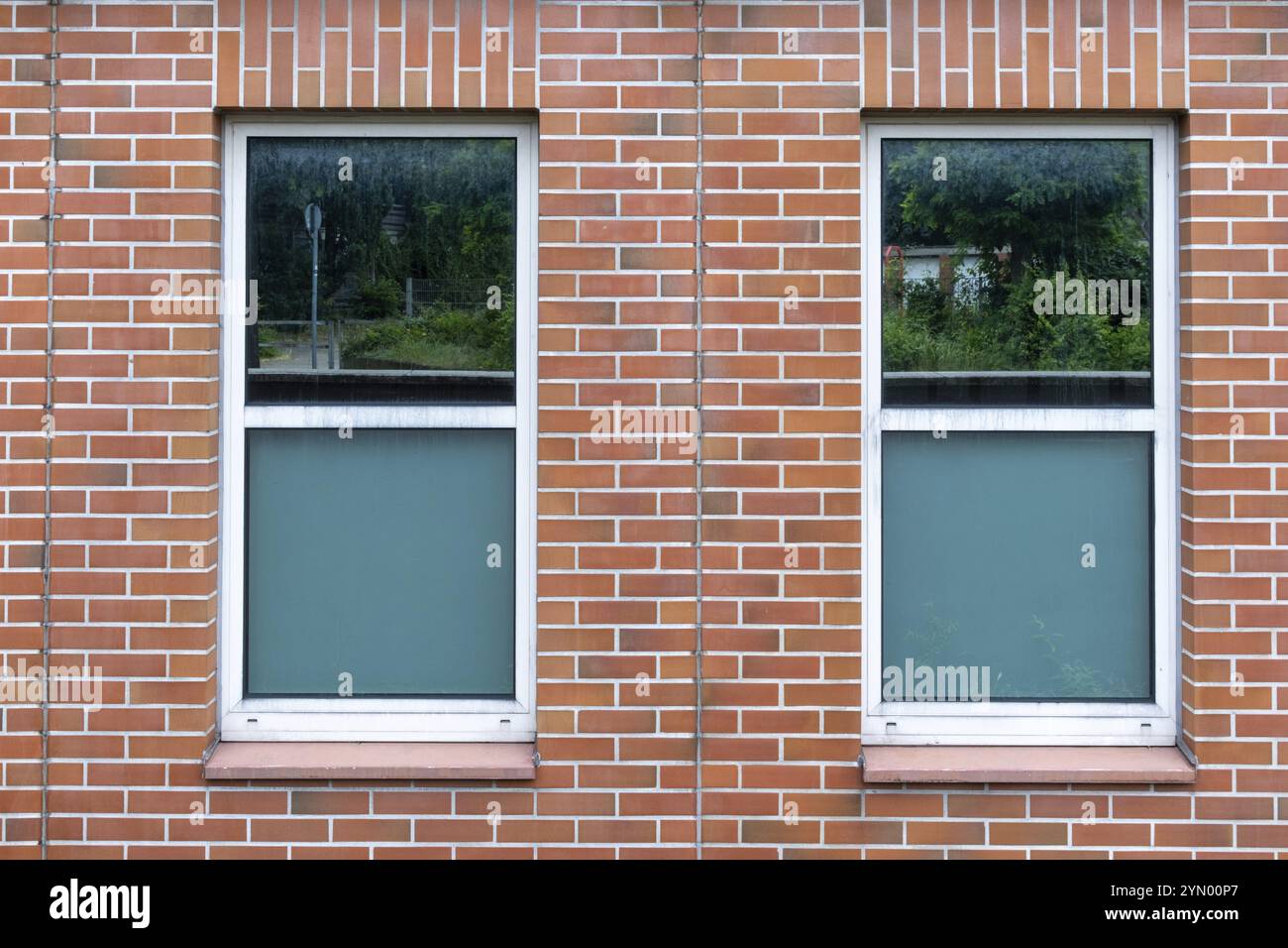 Brick house wall with even windows Stock Photo - Alamy