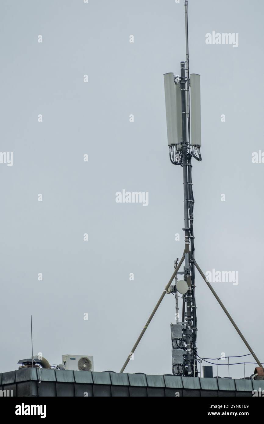 Large mobile radio antennas on an office roof Stock Photo - Alamy
