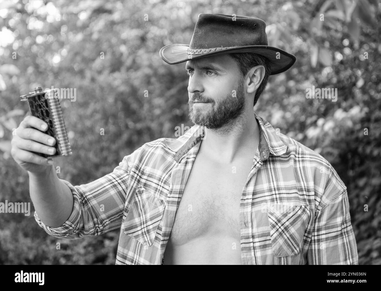 western man offer whiskey flask wear checkered shirt outdoor Stock ...