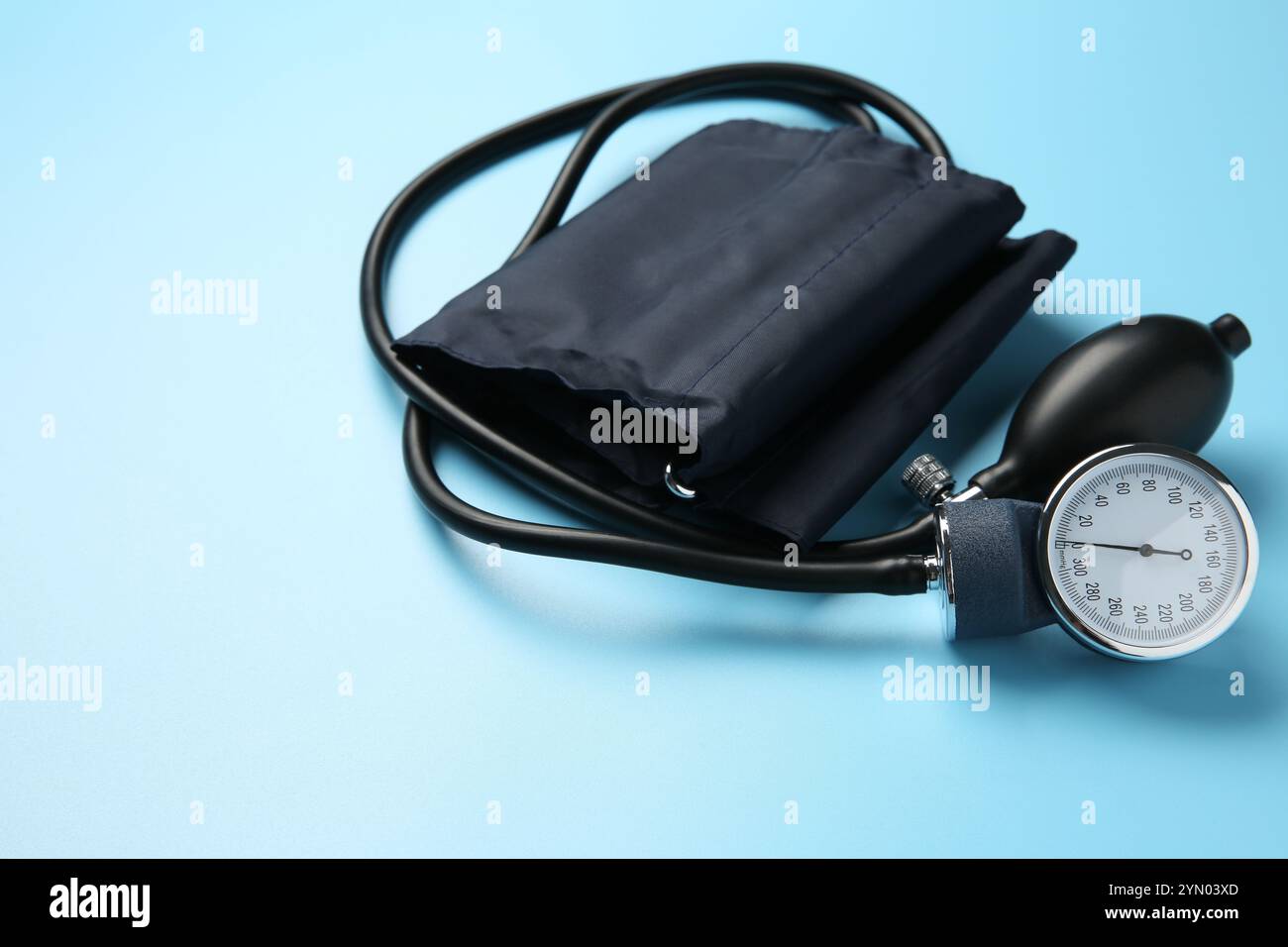 Blood pressure measuring device on light blue background Stock Photo ...