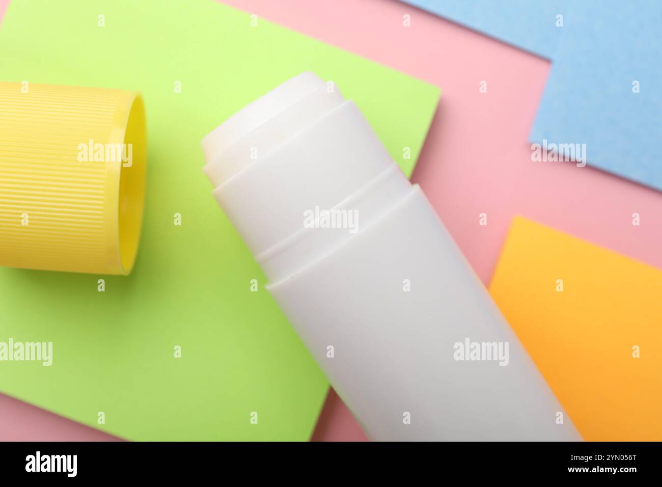 Stick of glue and notes on pink background, flat lay Stock Photo - Alamy
