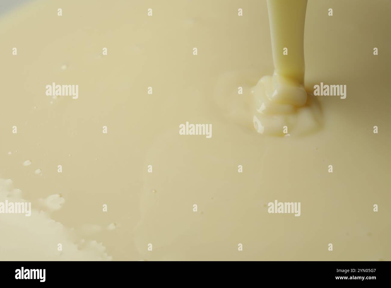 Pouring delicious condensed milk as background, closeup Stock Photo - Alamy