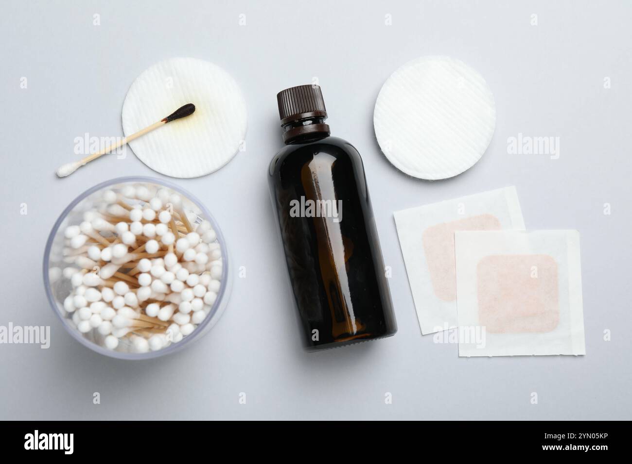 Topical iodine and other first aid kit components on light grey ...