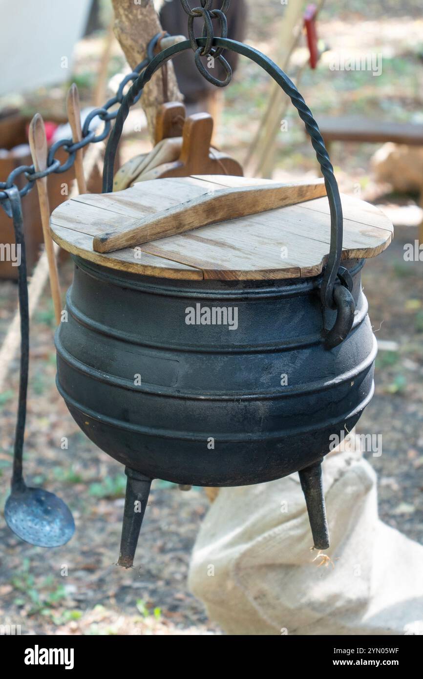 Hanging old metal cooking pot outdoors Stock Photo - Alamy